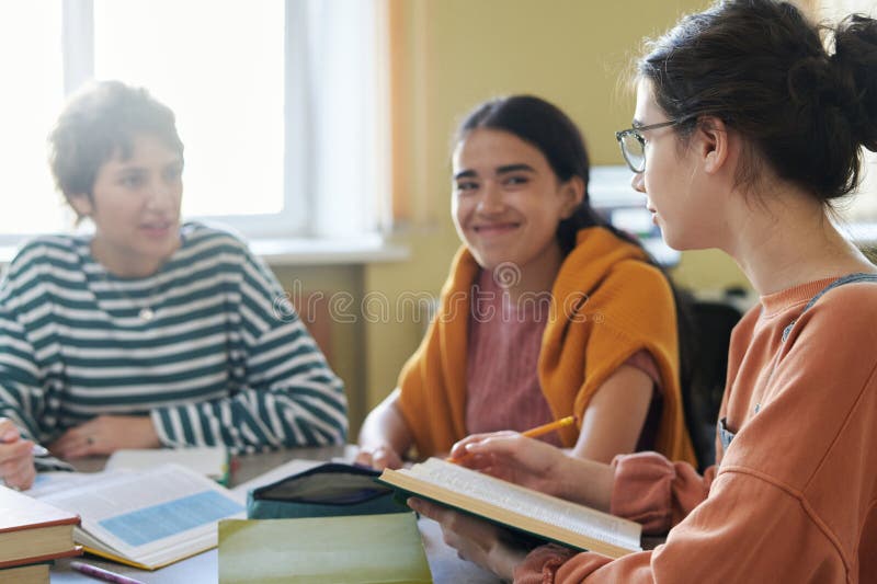 Studying Together in Library with Books and Notebooks Stock Photo ...