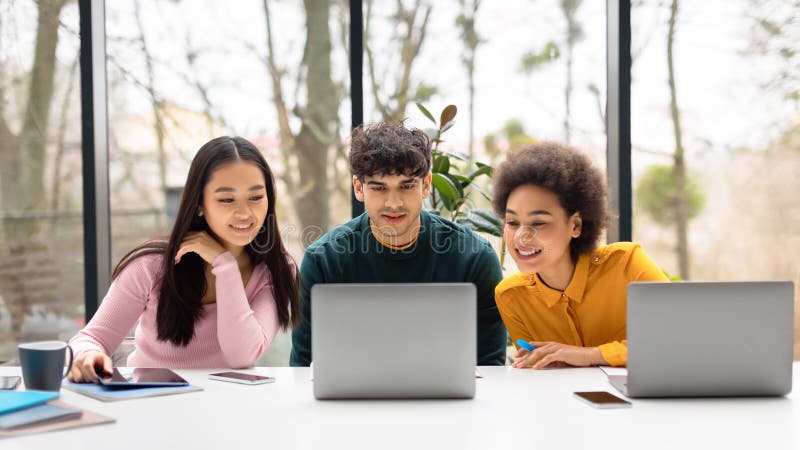 Studying Together. Three International Students Sitting at Desk in ...