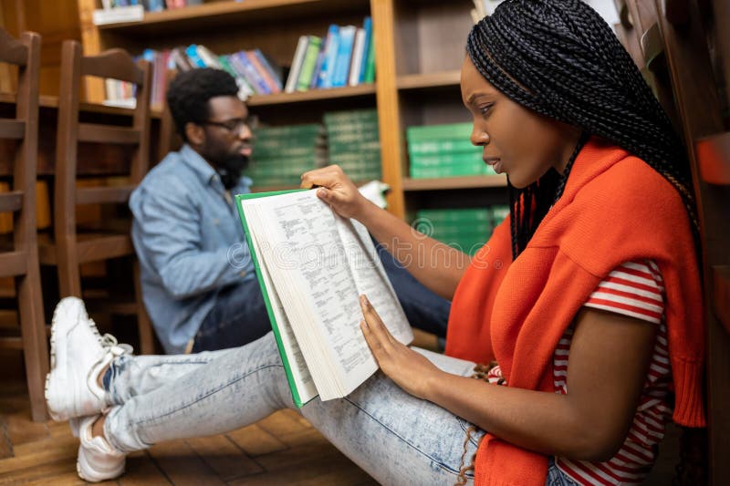 Young People Studying in the Library Together and Looking Involved ...