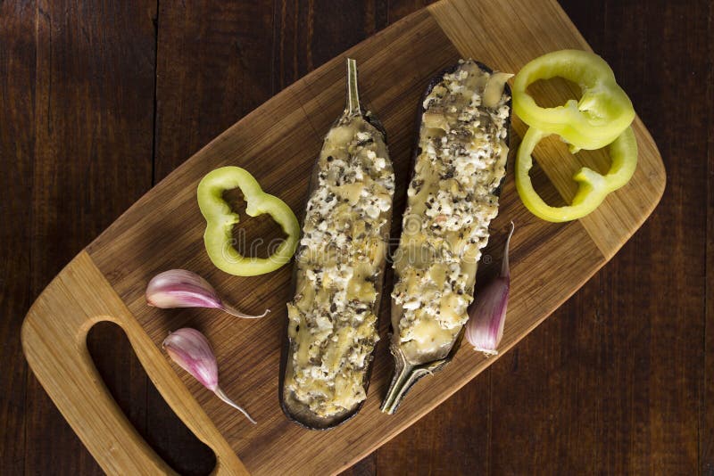 Stuffed Eggplant Dish on a Boards on the Kitchen Table with Garlic and ...
