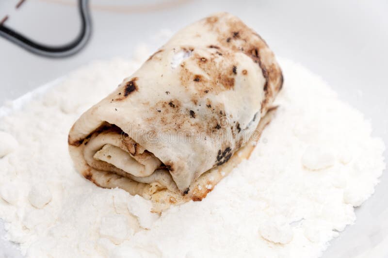 Stuffed Rolled Pancake in the Flour Ready for Paning Stock Image ...