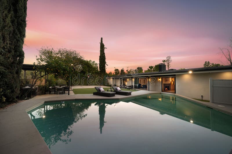 Backyard Retreat Featuring a Sleek Swimming Pool and Vibrant Sunset ...