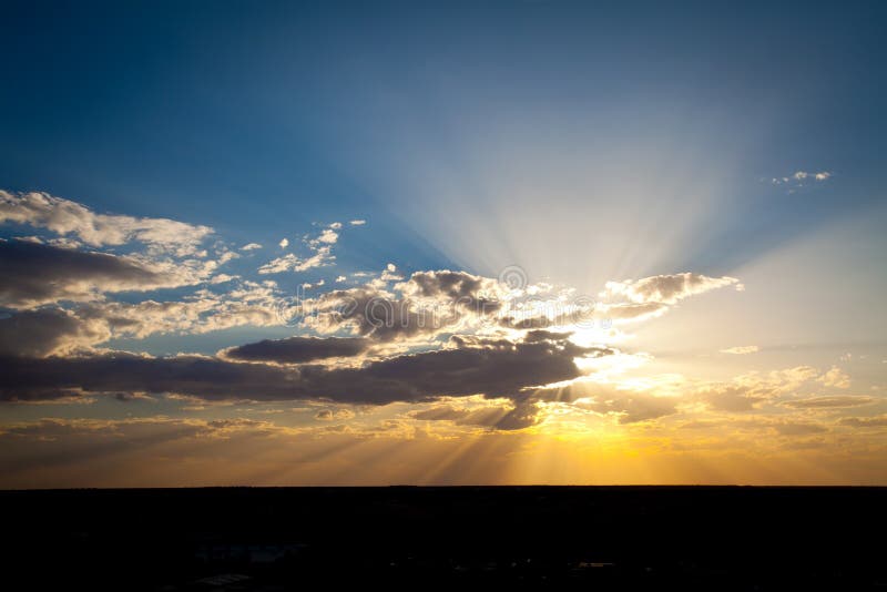 Stunning Blue and Gold Sunset with Beaming Sunrays Stock Image - Image ...