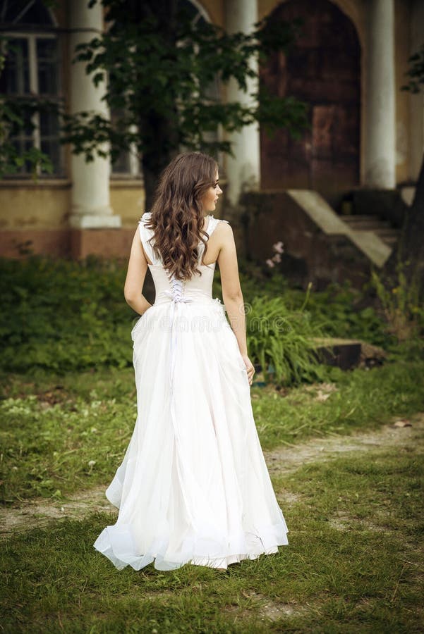 Stunning Bride Gracefully Poses in a Spring Park, among Blossoming ...