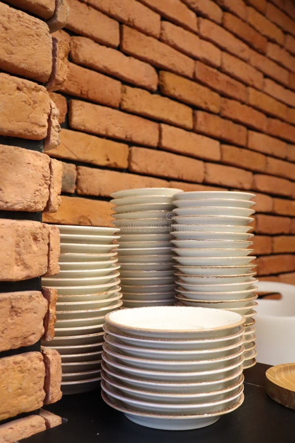 A Stunning Display of Stacked Plates Placed Gracefully Against a Rustic ...