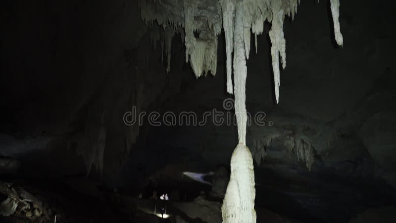 Stunning Illuminated Stalactite Lamp in Underground Cave Exploration ...