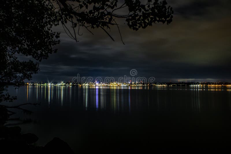 A Lake is Illuminated with Lights at Night on the Shore Stock Photo ...