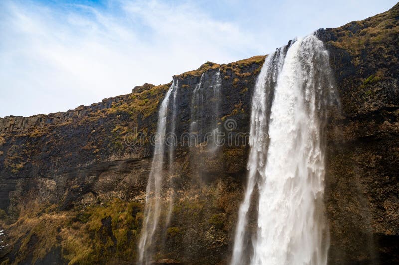 This Waterfall is Running Down a Rocky Hill Side into the Ocean Stock ...
