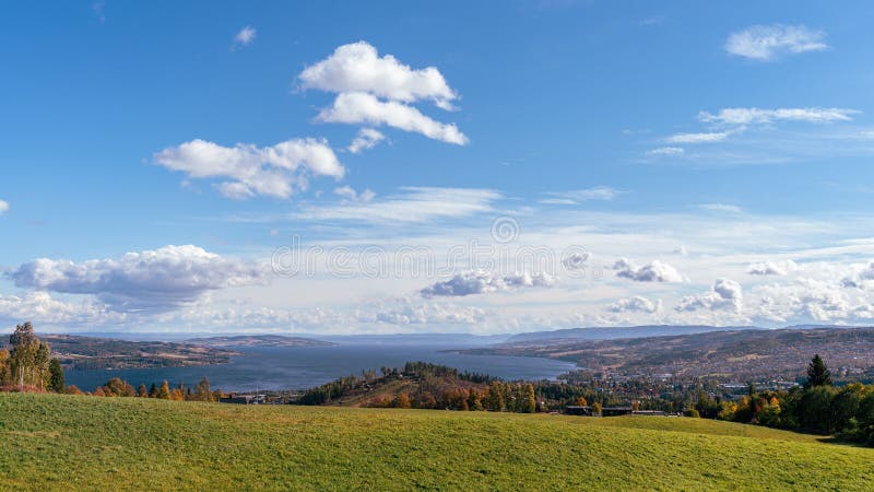 Stunning Landscape Featuring a Wide Open Field and a Tranquil Lake in ...