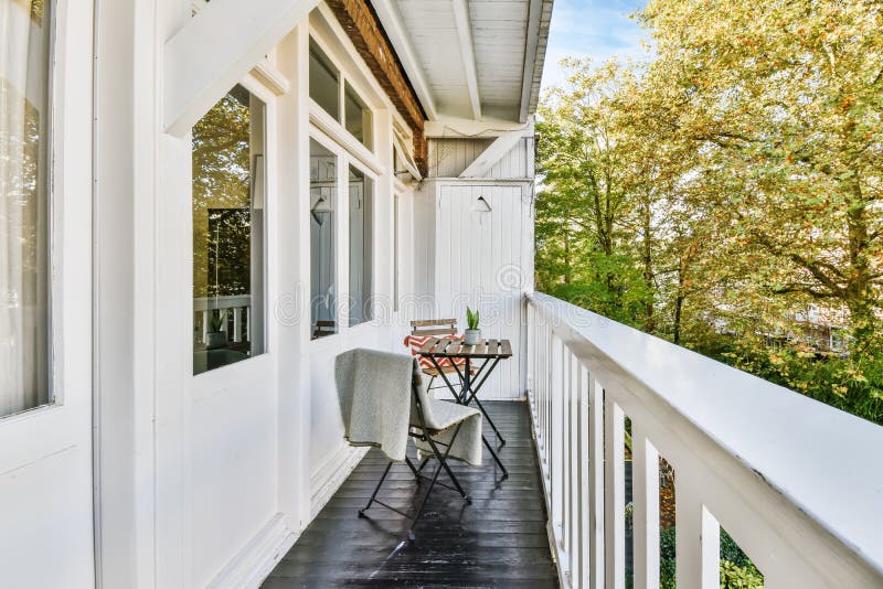 Stunning Long White Balcony with Table and Chair Stock Photo - Image of ...