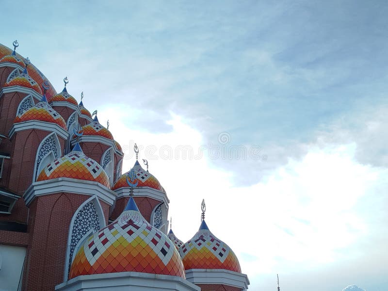 A Stunning Mosque with Vibrant Orange Domes and Intricate Patterns ...