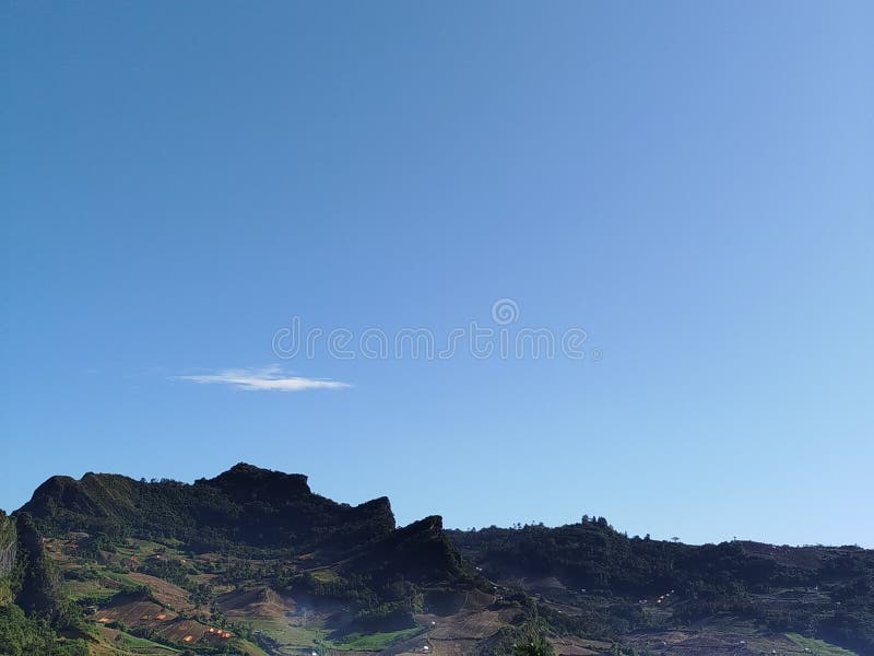 A Stunning Mountain Landscape Under a Vast Blue Sky, with a Single ...