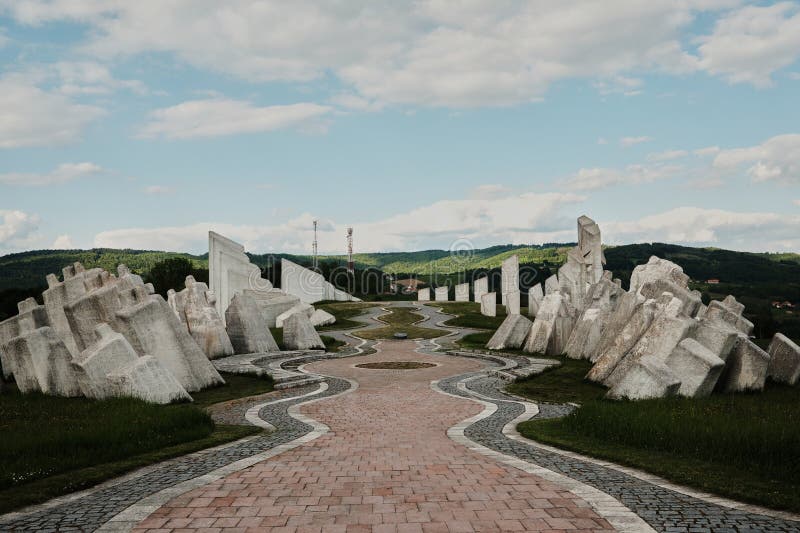 A Stunning Pathway Lined with Abstract Concrete Figures Symbolizes ...