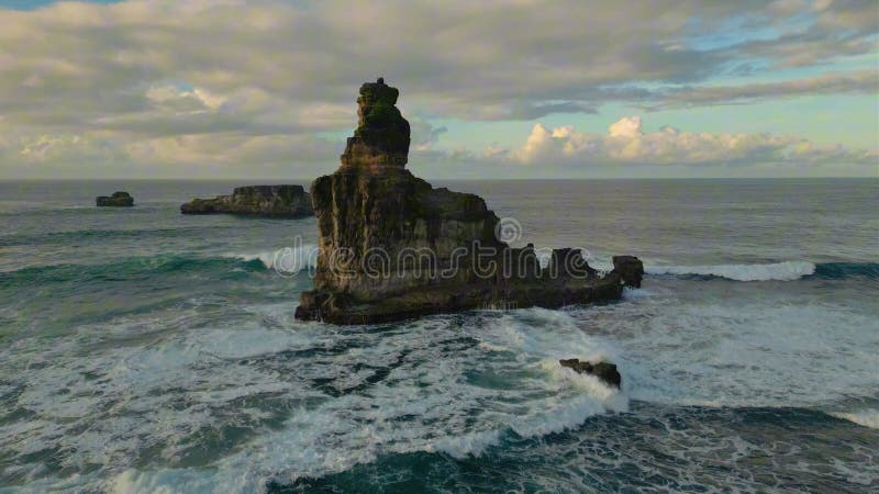 Stunning Sea Stack Rises Amidst the Powerful Ocean Waves in Pacitan ...