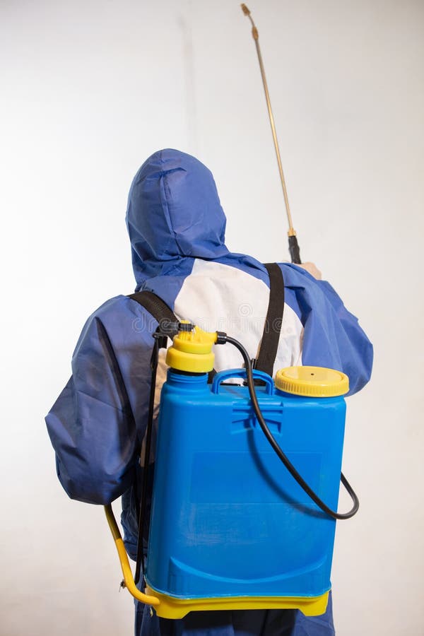 Stunning Shot of a Professional Exterminator Spraying a Chemical Over a ...
