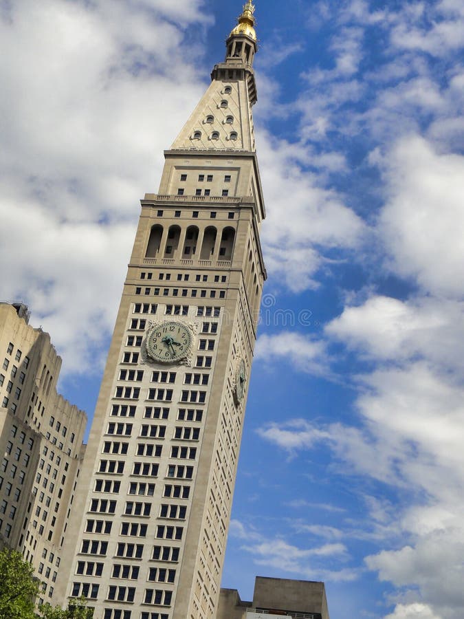 A Skyscraper with a Clock Tower Atop, Piercing the Blue Sky New York ...