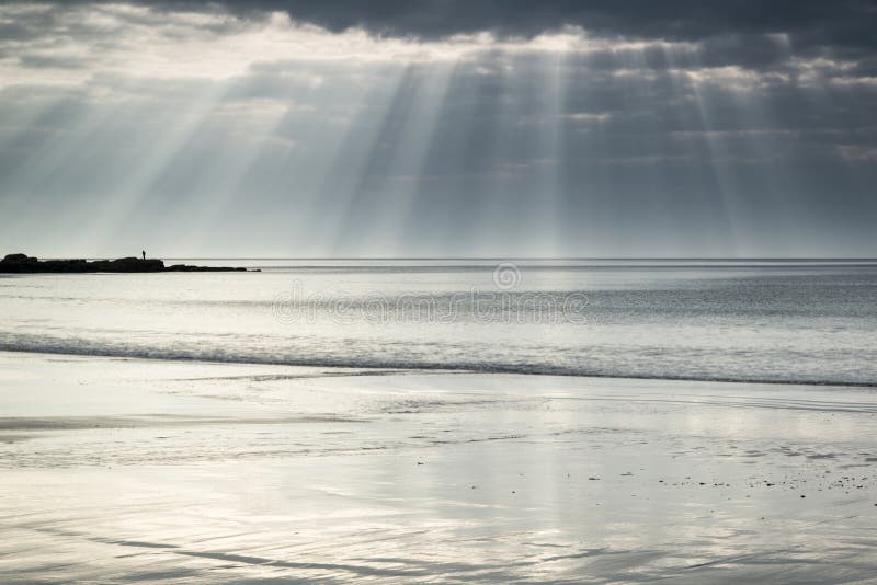 Stunning Sun Rays Bursting from Sky Over Empty Yellow Sand Beach Stock ...