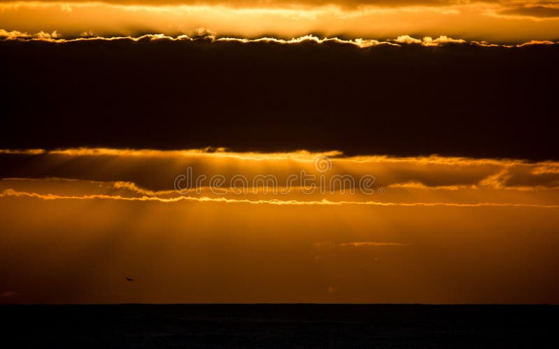 Stunning Sunset with Dramatic Clouds and Sun Rays Over the Ocean ...