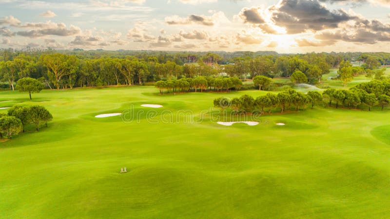 A Stunning Sunset View of a Golf Course with Sand Traps and Vibrant ...