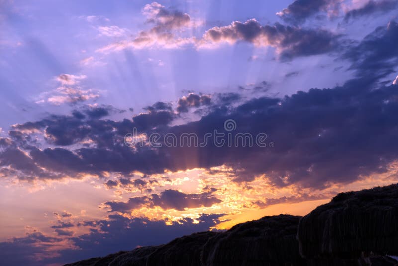 Stunning Vibrant Purple Sunset Illuminating the Rocky Cliffs Stock ... Stunning Vibrant Purple Sunset Illuminating the Rocky Cliffs Stock ...
