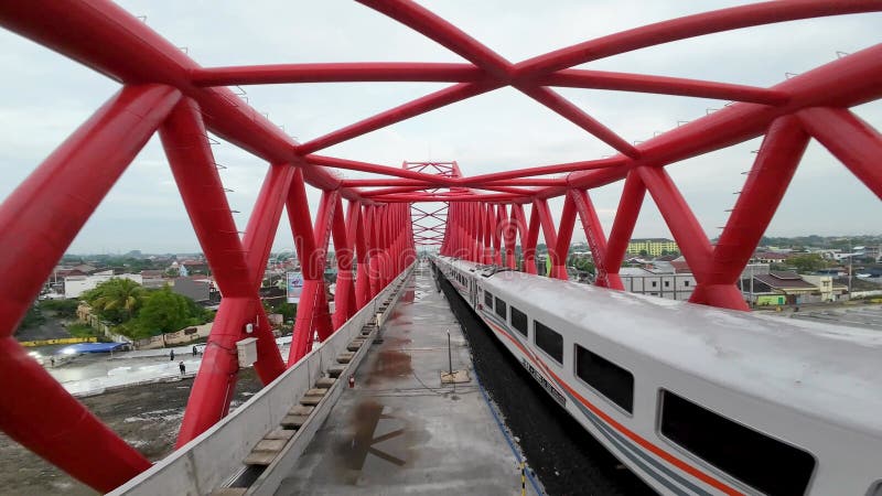 A Stunning View Captures a Train Gliding through a Red Bridge Tunnel ...