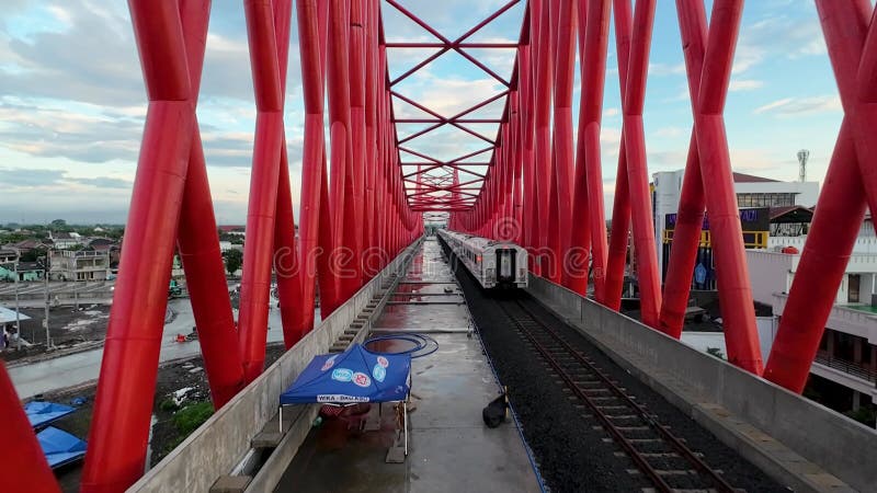 A Stunning View Captures a Train Gliding through a Red Bridge Tunnel ...