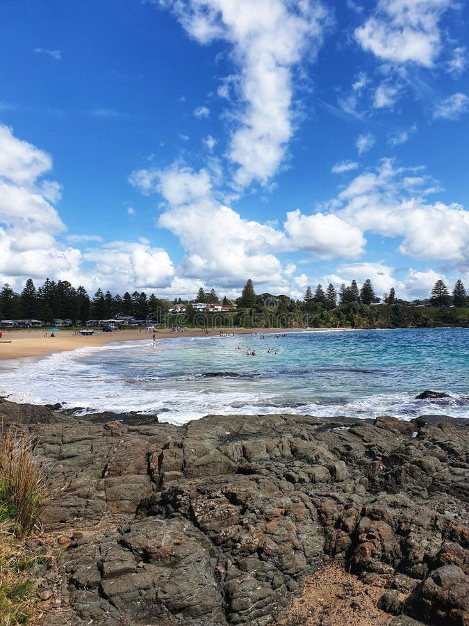 Stunning View of Crystal Clear Ocean Beach with Rolling Waves and a ...