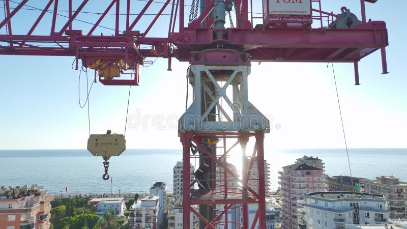Aerial View: Operator Assembles Components and Navigates Ladders ...