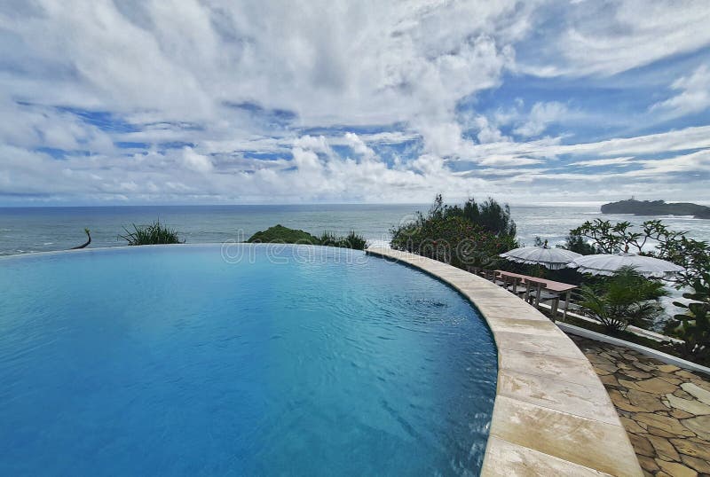Infinity pool by the sea stock photo. Image of wave - 263054042