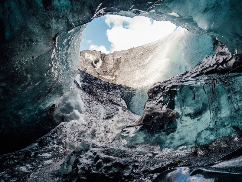 Stunning View from Inside a Blue Ice Cave with Sunlight Streaming ...