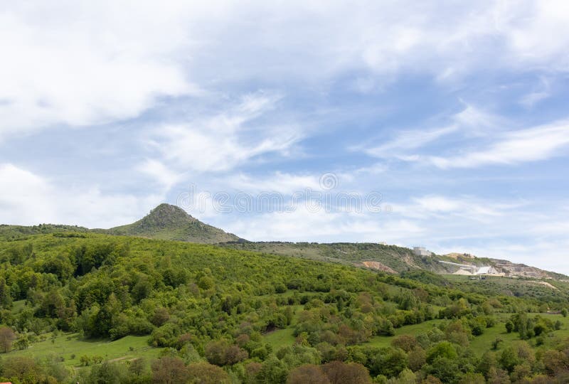 A Stunning View of a Lush Green Mountain Landscape Under a Bright Blue ...