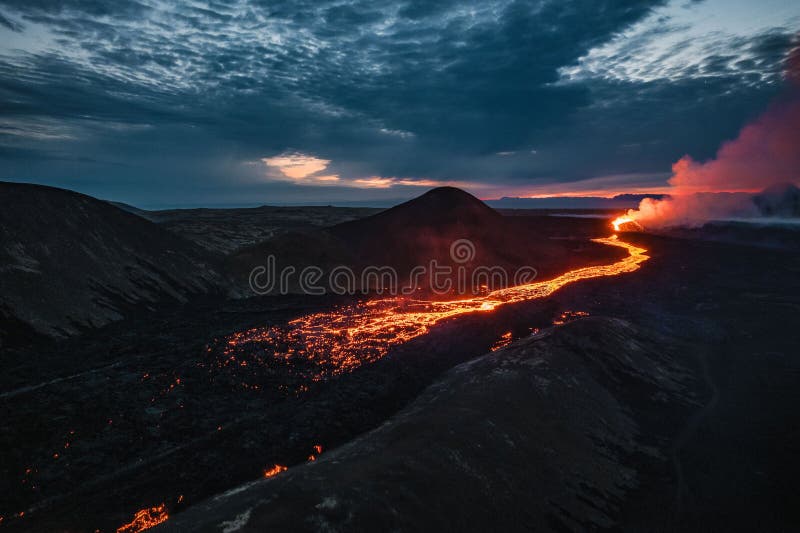 Stunning View of a Volcanic Eruption with Flowing Lava during Sunset ...