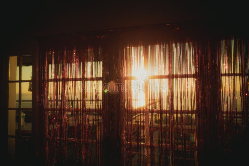 Stunning View of a Window with Sheer White Curtains and the Sun Setting ...