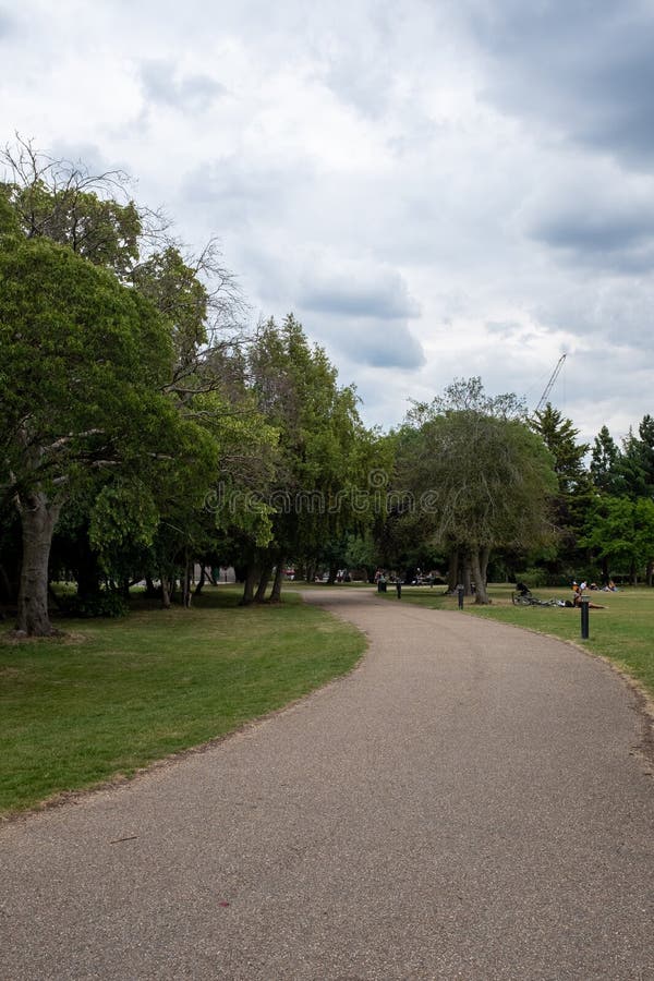 A Stunning Walk Path in the Middle of the Park, Cloudy Grey Sky Above ...