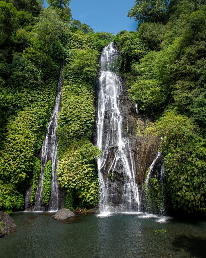 Waterfall Cascading Down Lush Cliffs Stock Image - Image of cascade ...