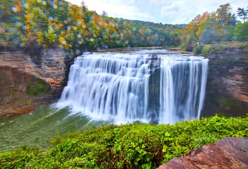 Stunning Waterfall Pouring Over Cliffs with Drops Splashing on Lens and ...