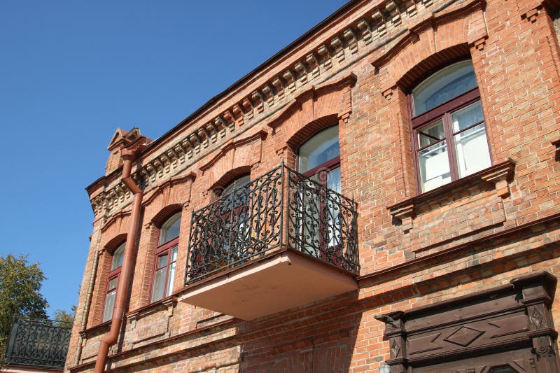 A Sturdy Brick Building Featuring a Spacious Balcony Located on the ...