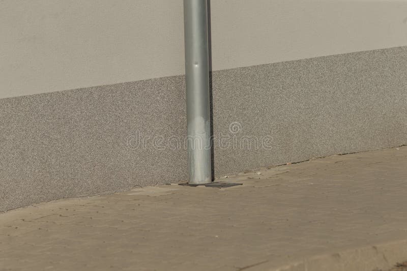 A Sturdy Metal Pole is Currently Positioned on the Ground beside a Wall ...