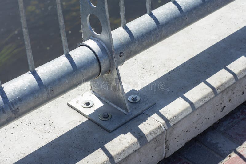 A Sturdy Metal Railing is Bolted To a Concrete Base Stock Image - Image ...