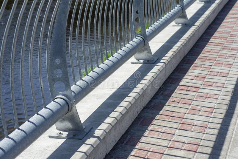 A Sturdy Metal Railing is Bolted To a Concrete Base Stock Photo - Image ...