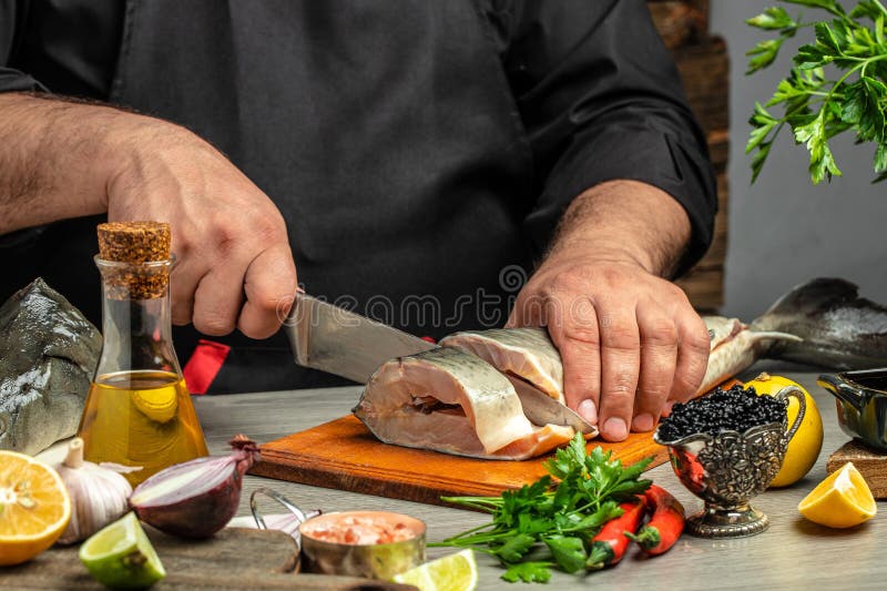 Sturgeon Fish on a Dark Background, the Chef is Holding a Large Raw ...