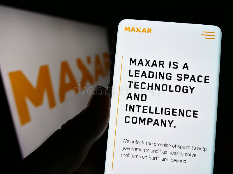 Person Holding Cellphone with Webpage of US Space Company Maxar ...