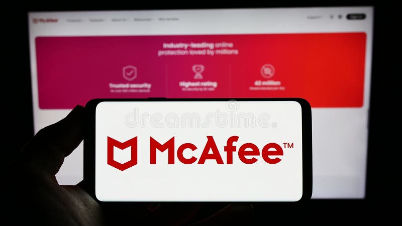 Person Holding Smartphone with Logo of Security Software Company McAfee ...
