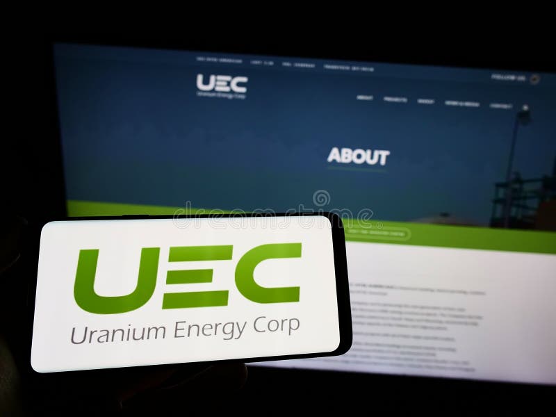 Person Holding Smartphone with Logo of US Mining Company Company ... Person Holding Smartphone with Logo of US Mining Company Company ...
