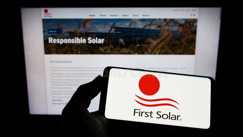 Person Holding Smartphone with Logo of US Renewable Energy Company ... Person Holding Smartphone with Logo of US Renewable Energy Company ...