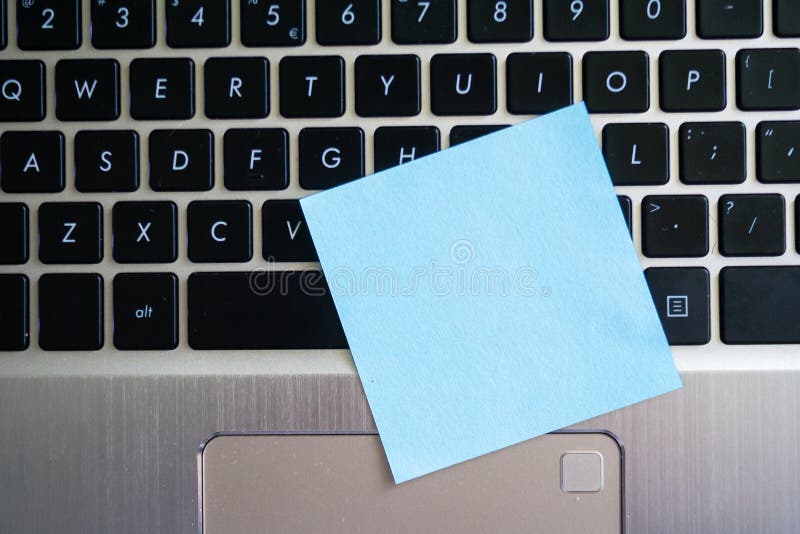 Style Image of Modern Laptop Computer Keyboard. Blue Sticky Note To the ...