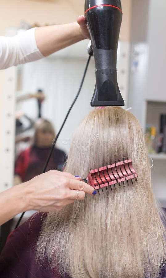 Styling female hair dryer stock image. Image of stylist - 88573473