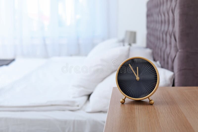 Stylish Alarm Clock on Bedside Table Stock Photo - Image of modern ...