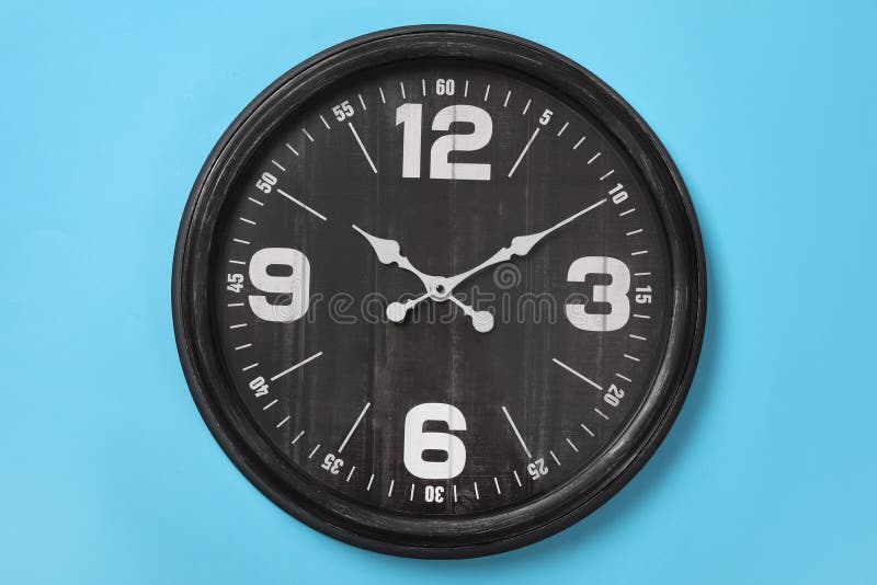 Stylish Analog Clock Hanging on Light Blue Wall Stock Image - Image of ...