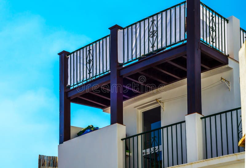 Stylish Balcony with a Metal Railing, Solid Architectural Element, a ...